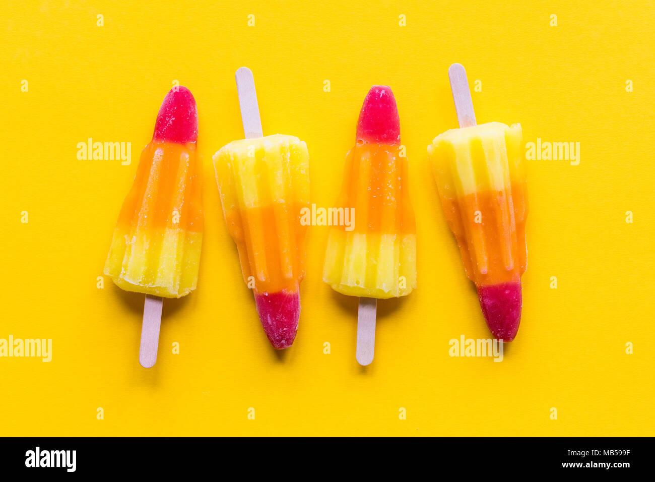 Rocket shaped summer ice lolly on a bright yellow background Stock ...