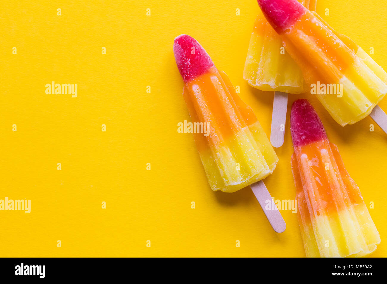 Rocket shaped summer ice lolly on a bright yellow background Stock ...