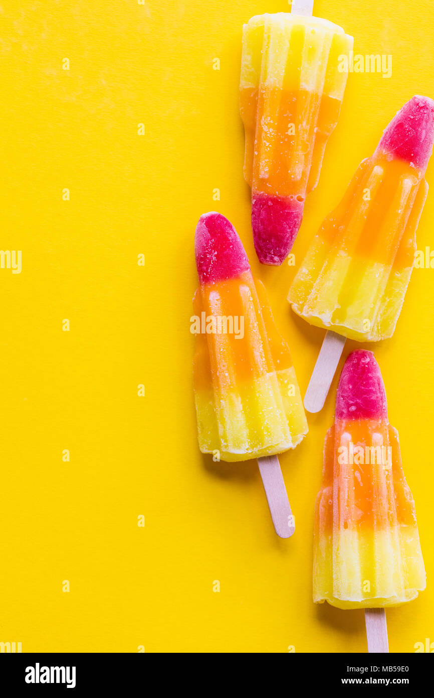 Rocket shaped summer ice lolly on a bright yellow background Stock ...