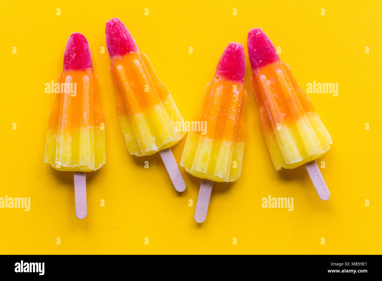 Rocket shaped summer ice lolly on a bright yellow background Stock ...