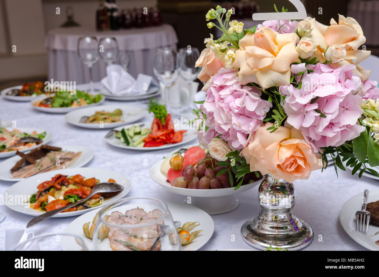 Table set for an event party or wedding reception. Banquet table in a ...