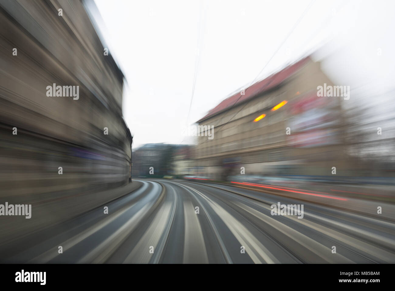 Photo of a motion blurred street taken from a streetcar giving a sense ...