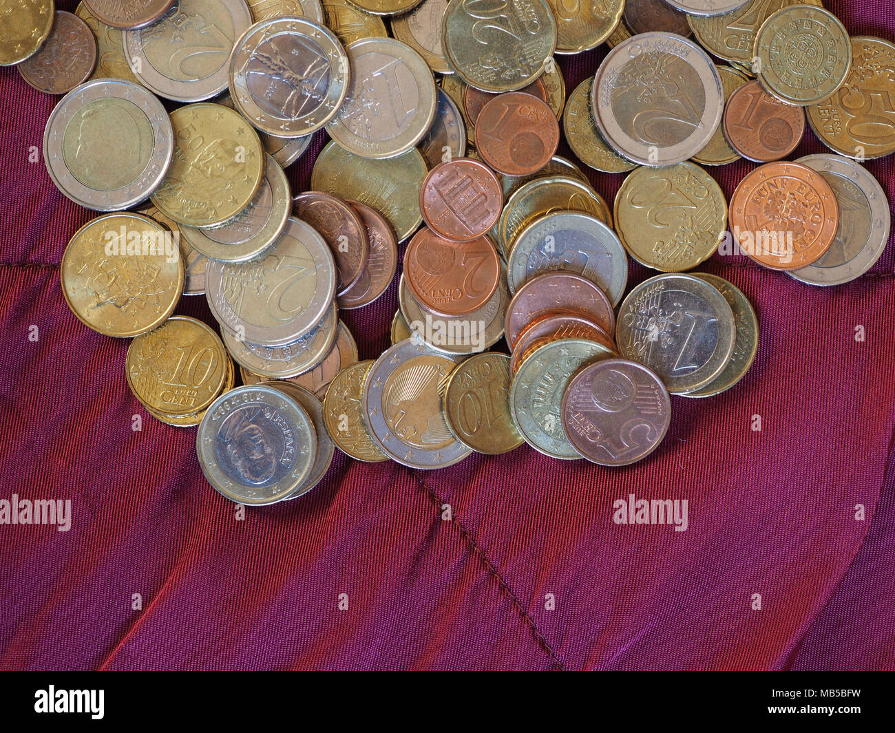 Euro coins money (EUR), currency of European Union over crimson red ...