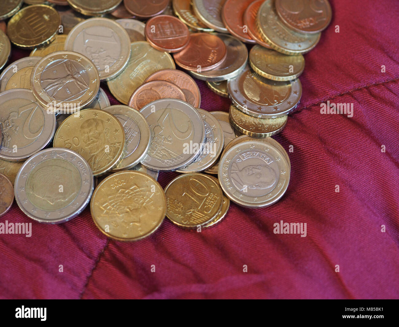 Euro coins money (EUR), currency of European Union over crimson red ...