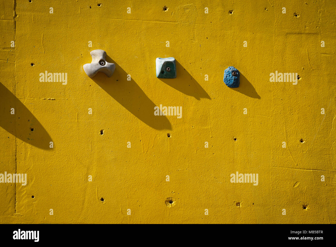 Man climbing rock wall yellow hi-res stock photography and images - Alamy