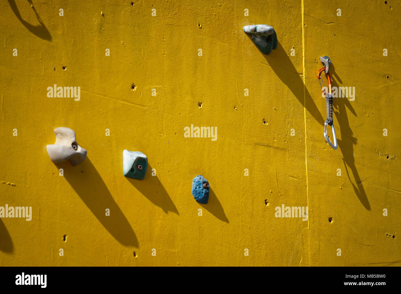 yellow artificial climbing wall with holds outdoor Stock Photo - Alamy