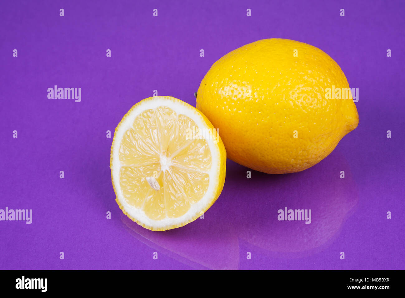 Lemon on purple background Stock Photo - Alamy