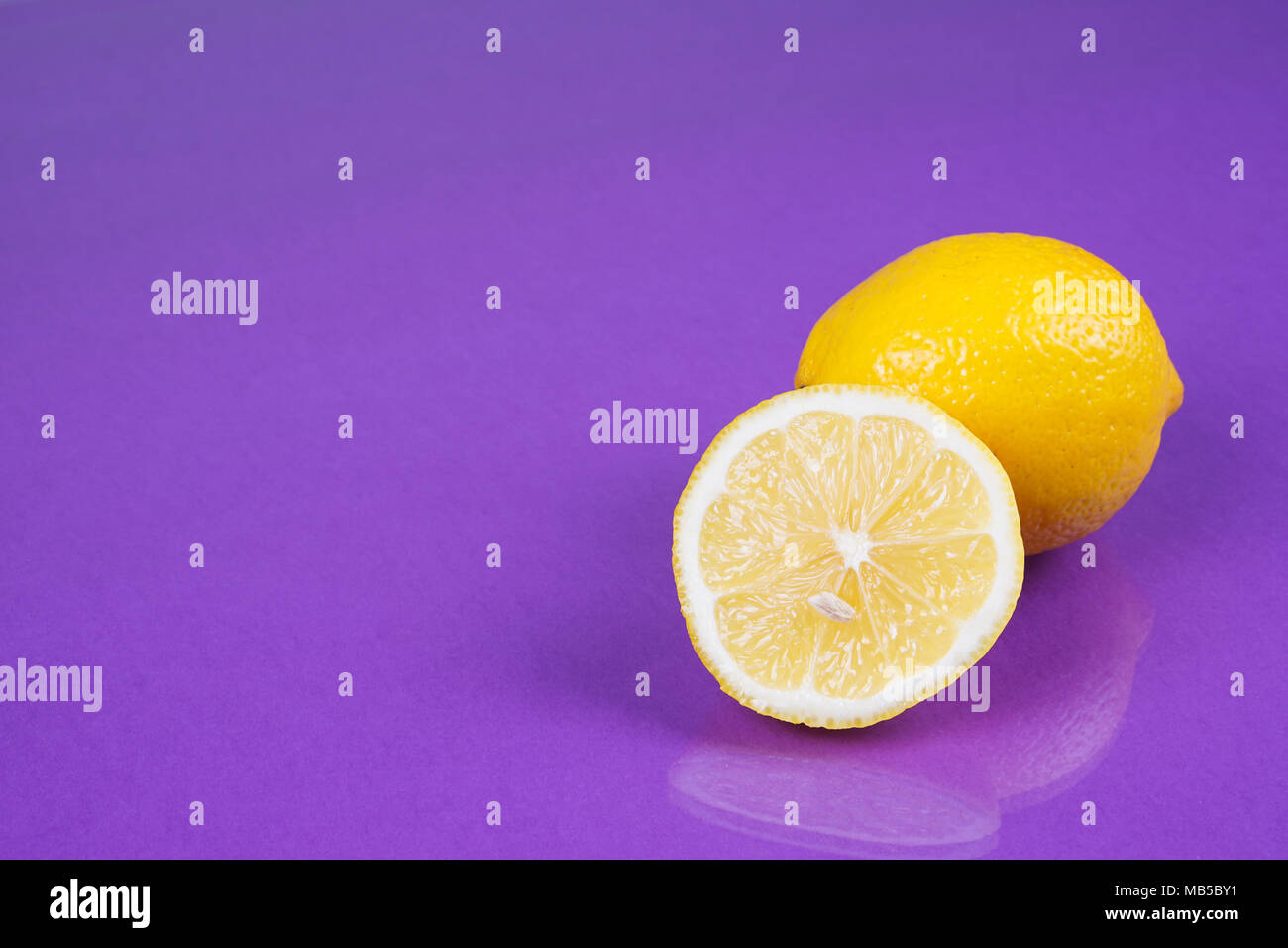 Lemon on purple background Stock Photo - Alamy