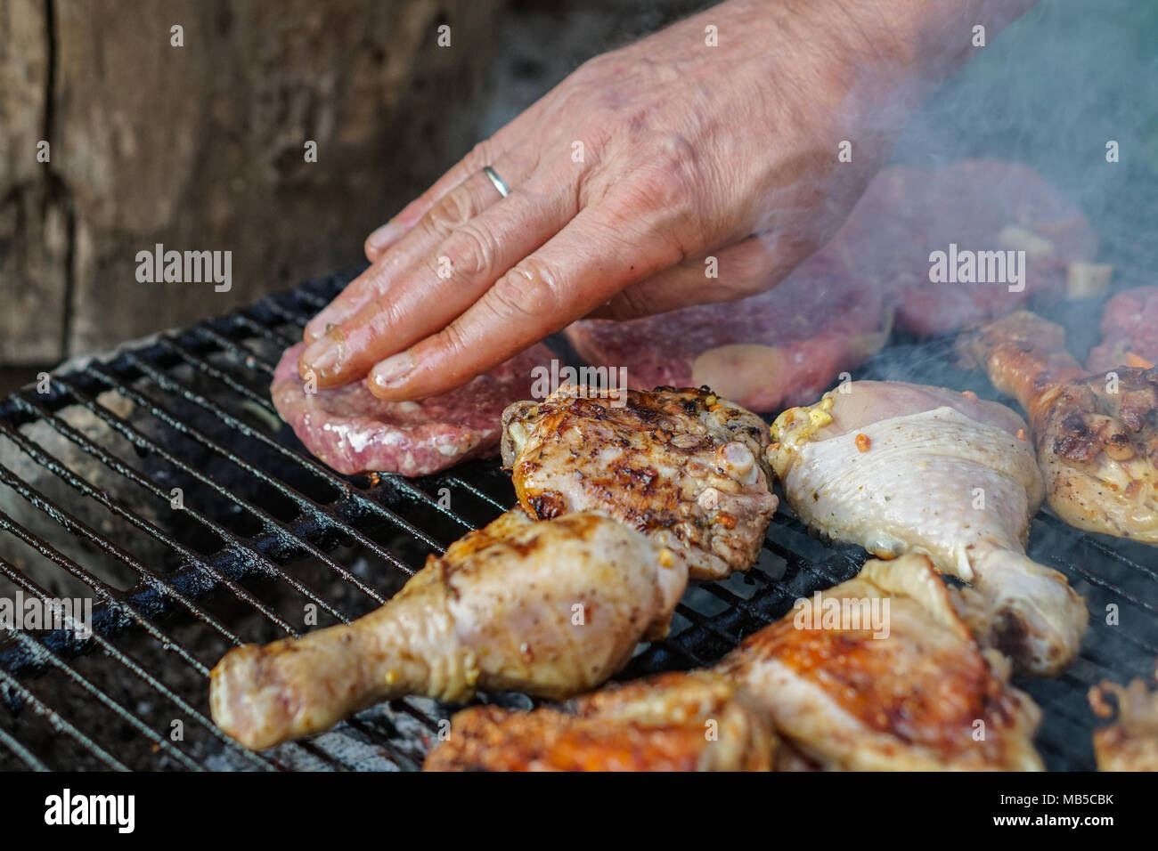 Raw meat on barbecue wire, barbecue preparation, outdoor scene Stock ...