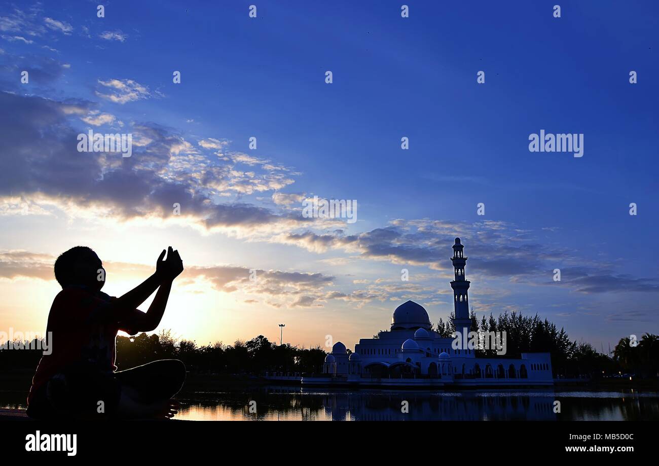 Silhouette muslim people praying at sunset Stock Photo - Alamy