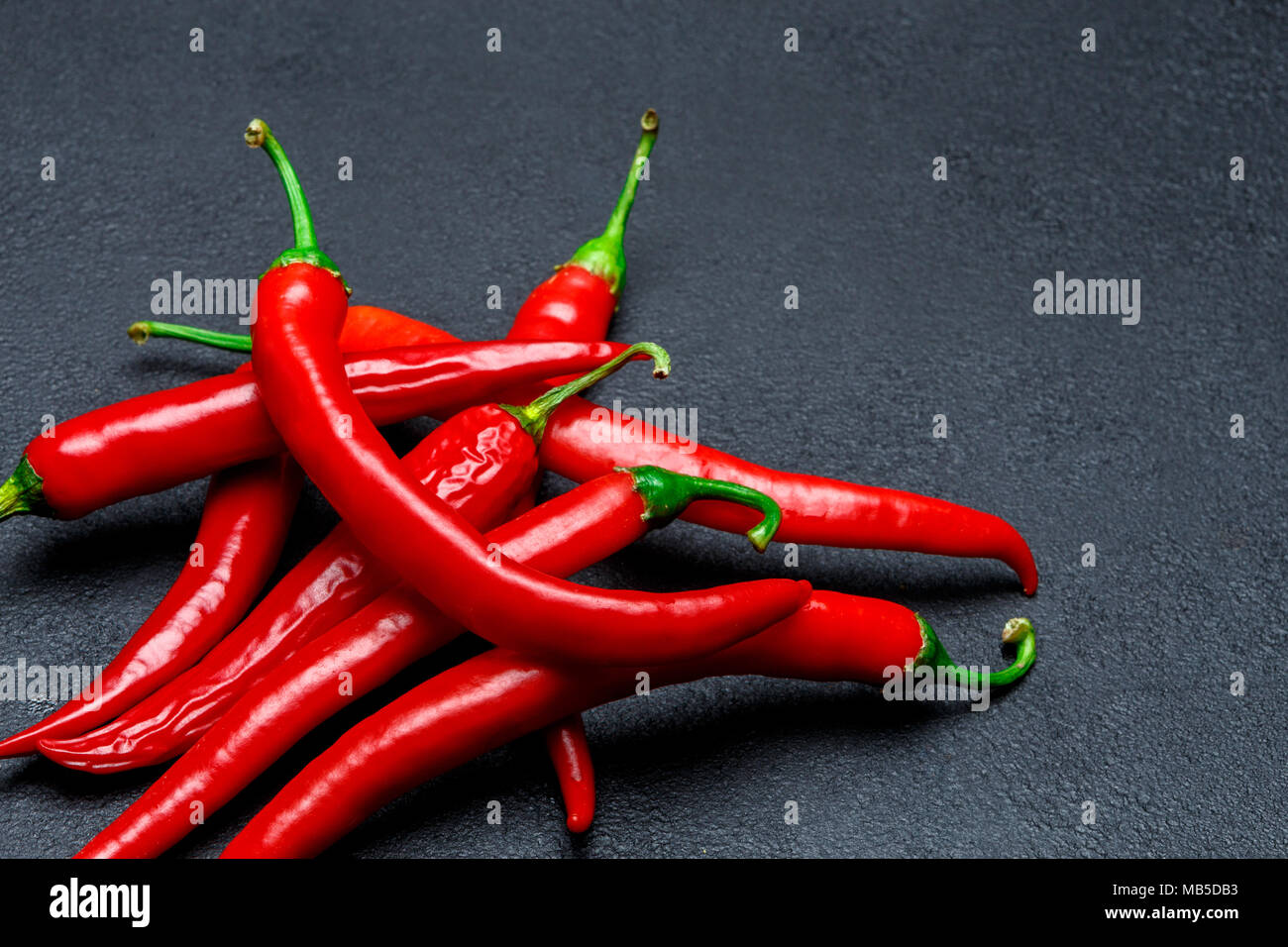 red chili pepper on dark concrete background Stock Photo - Alamy