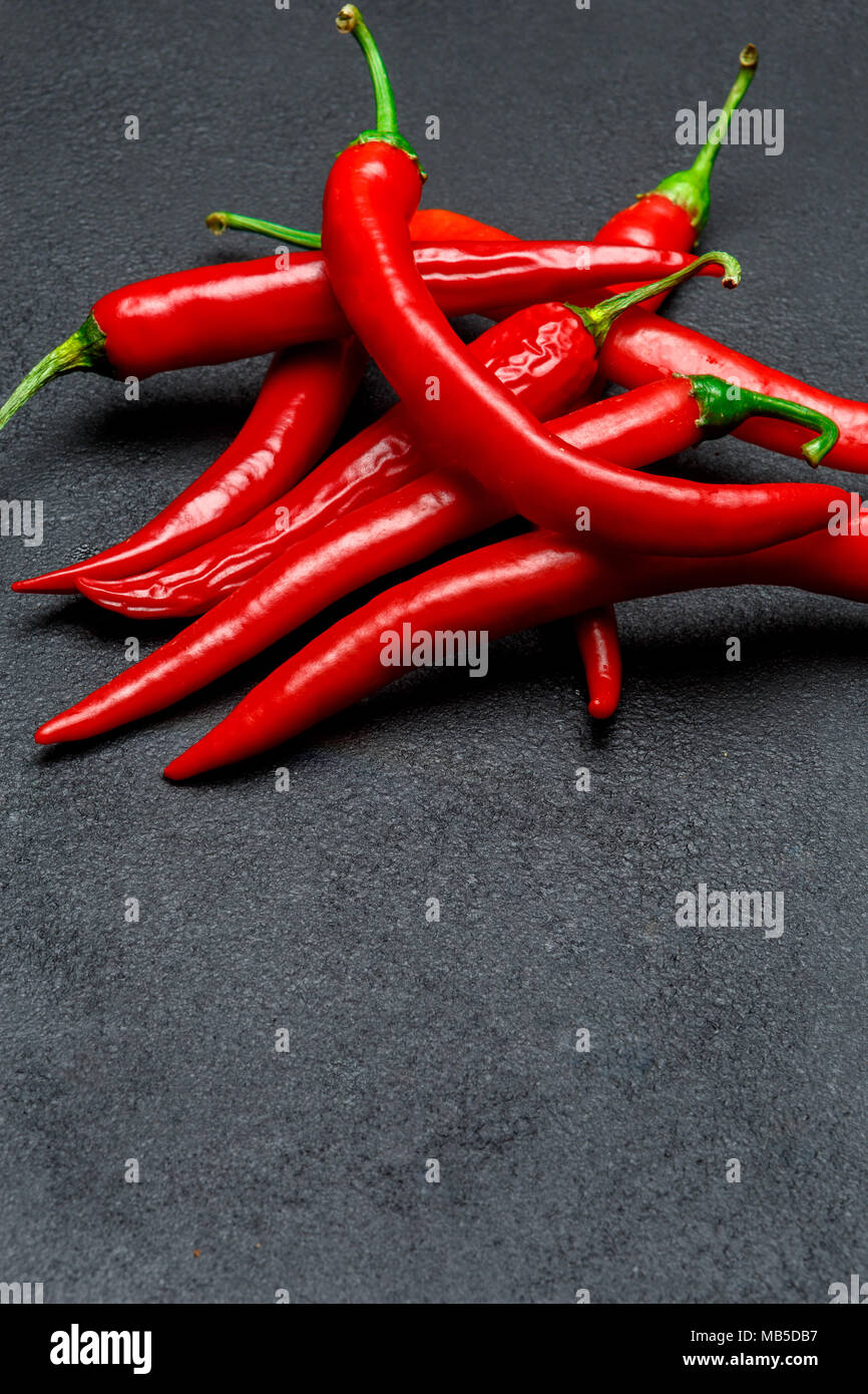 red chili pepper on dark concrete background Stock Photo - Alamy