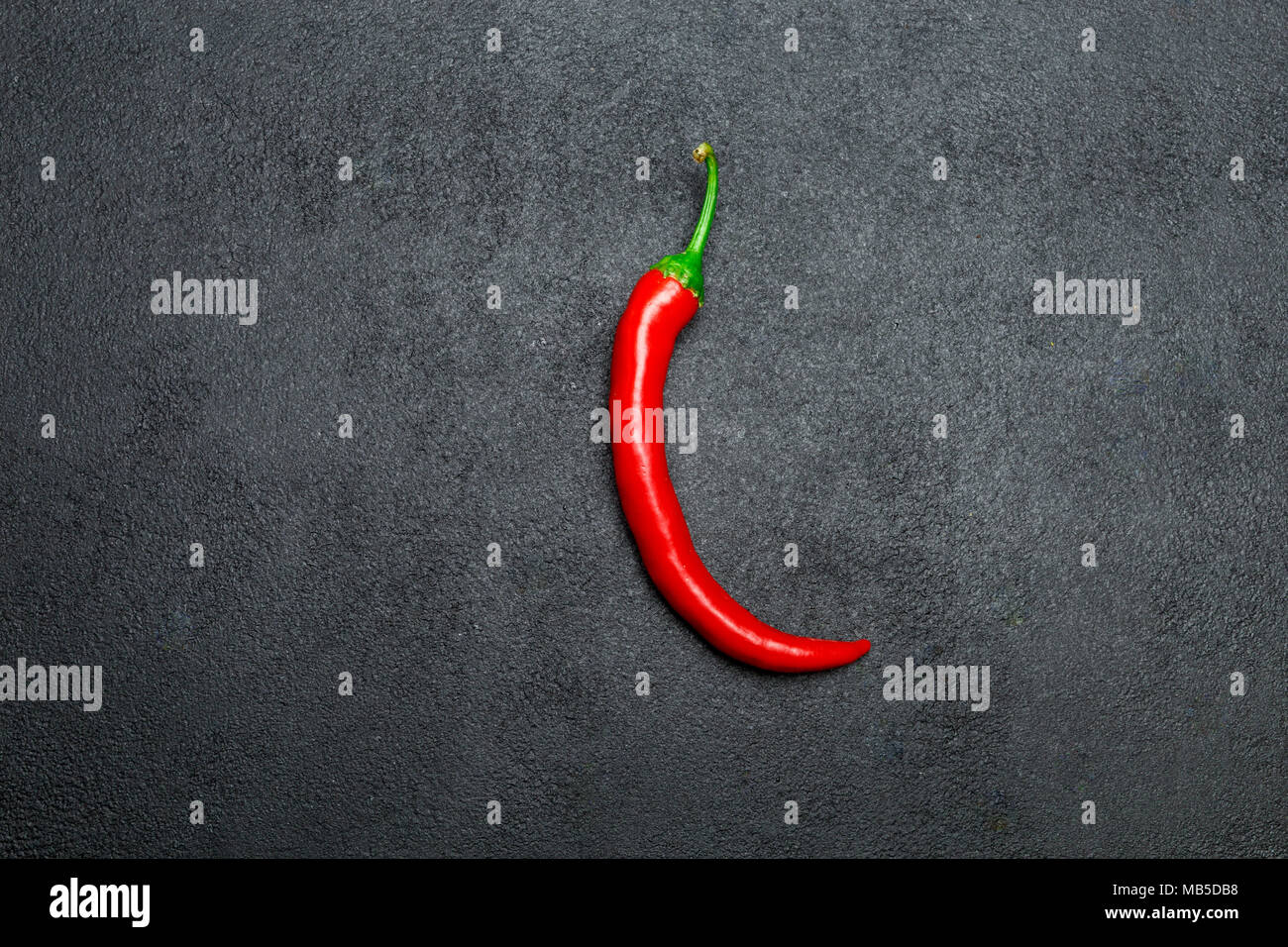 red chili pepper on dark concrete background Stock Photo - Alamy
