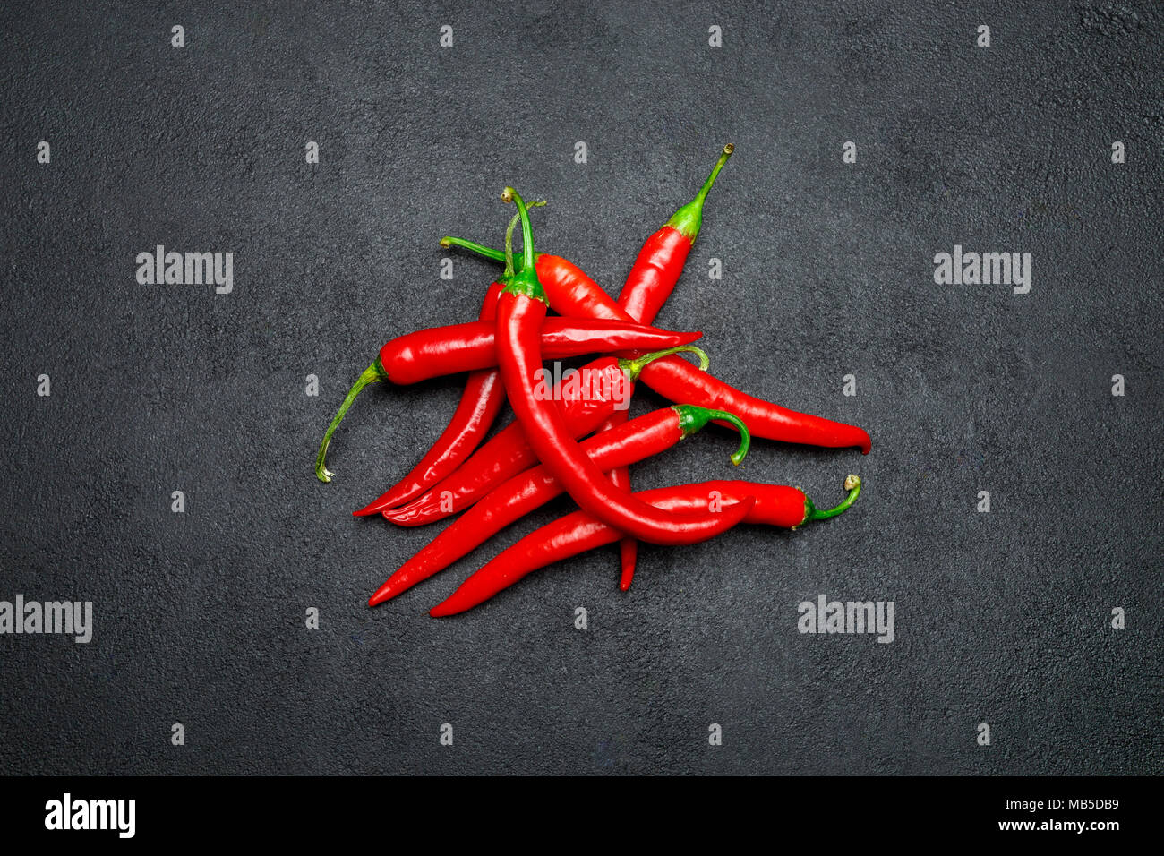 red chili pepper on dark concrete background Stock Photo - Alamy