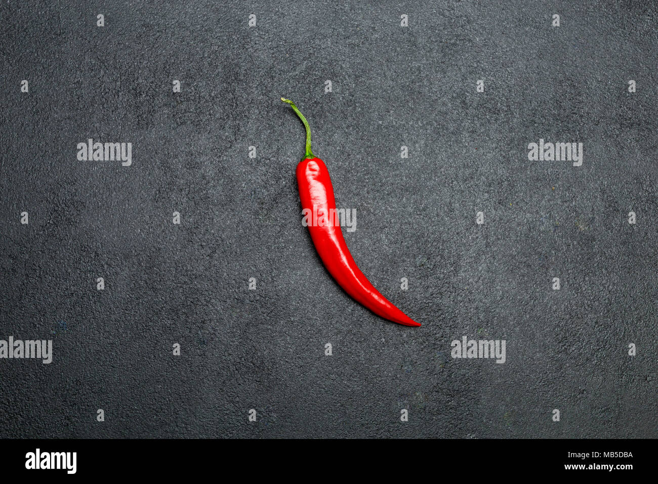 red chili pepper on dark concrete background Stock Photo - Alamy