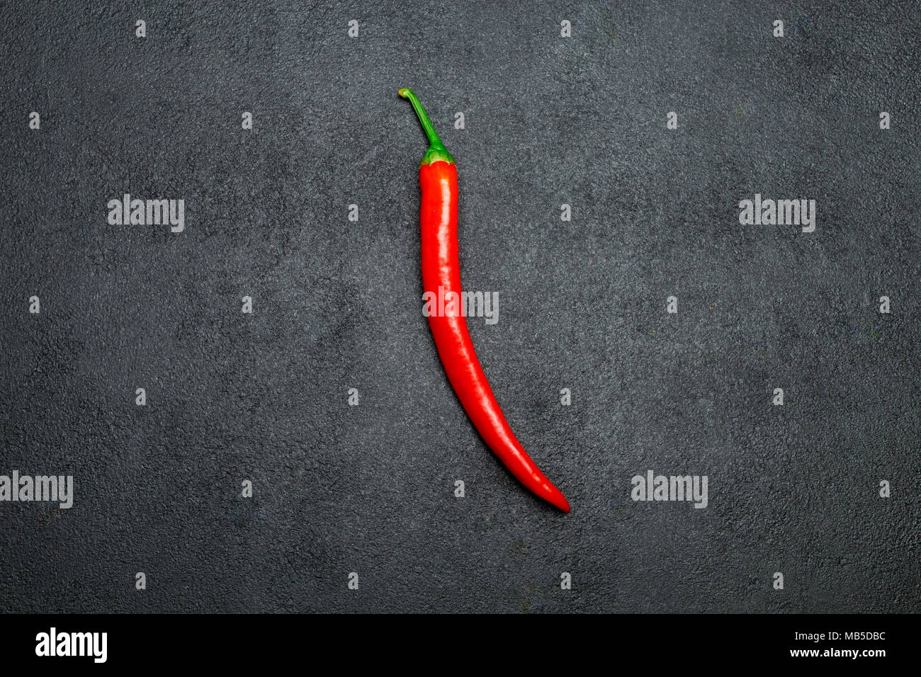 red chili pepper on dark concrete background Stock Photo - Alamy