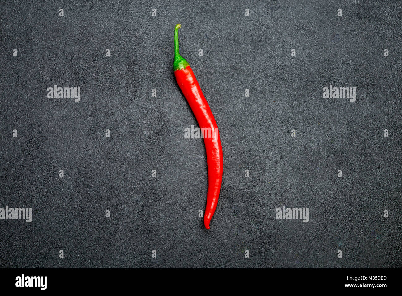 red chili pepper on dark concrete background Stock Photo - Alamy