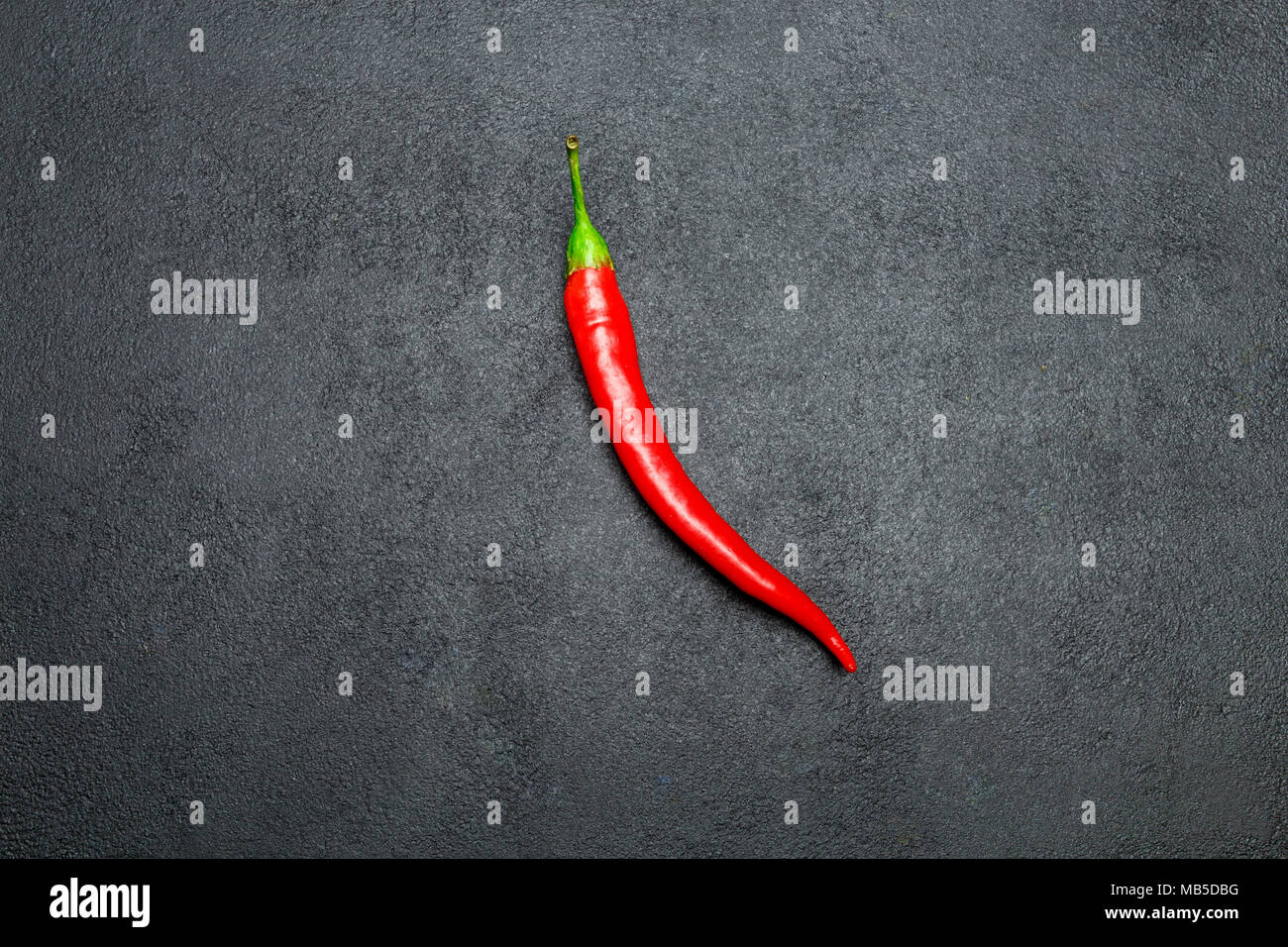 red chili pepper on dark concrete background Stock Photo - Alamy