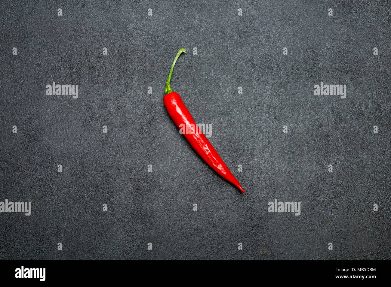 red chili pepper on dark concrete background Stock Photo - Alamy