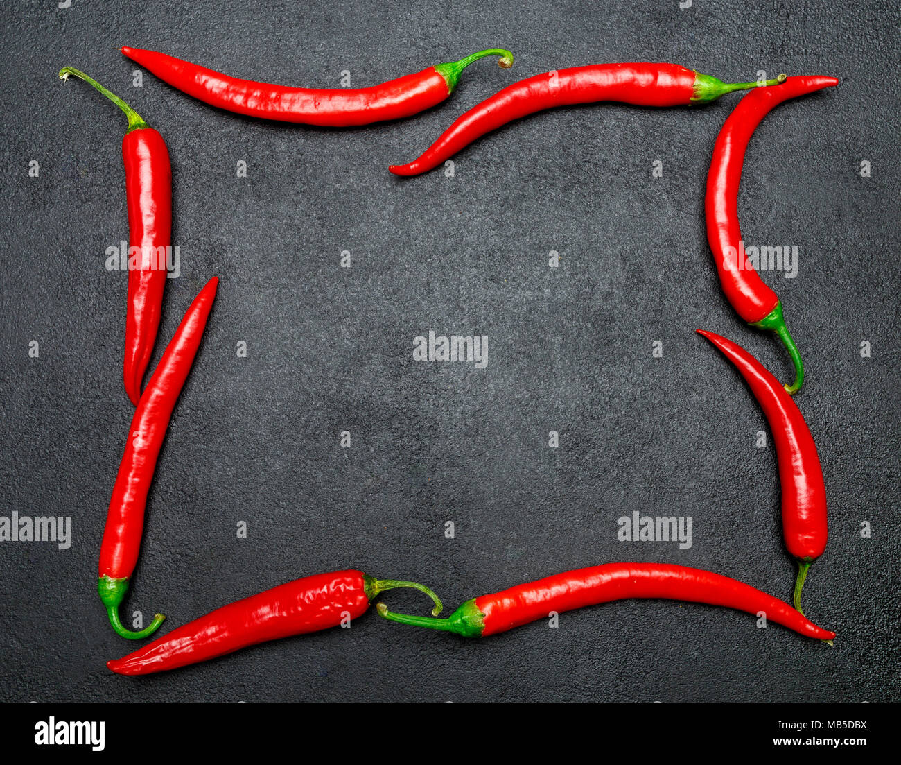 red chili pepper on dark concrete background Stock Photo - Alamy
