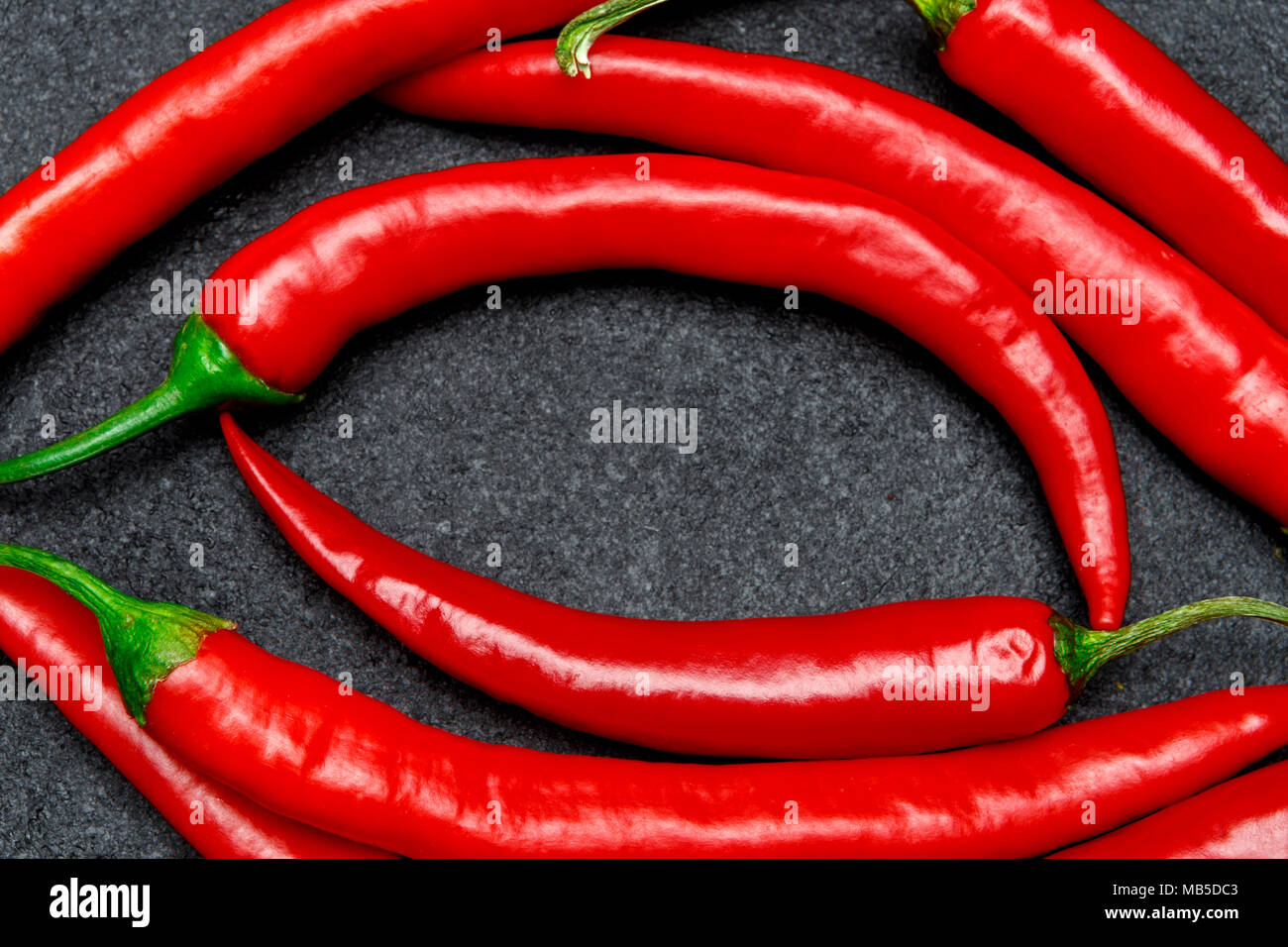red chili pepper on dark concrete background Stock Photo - Alamy