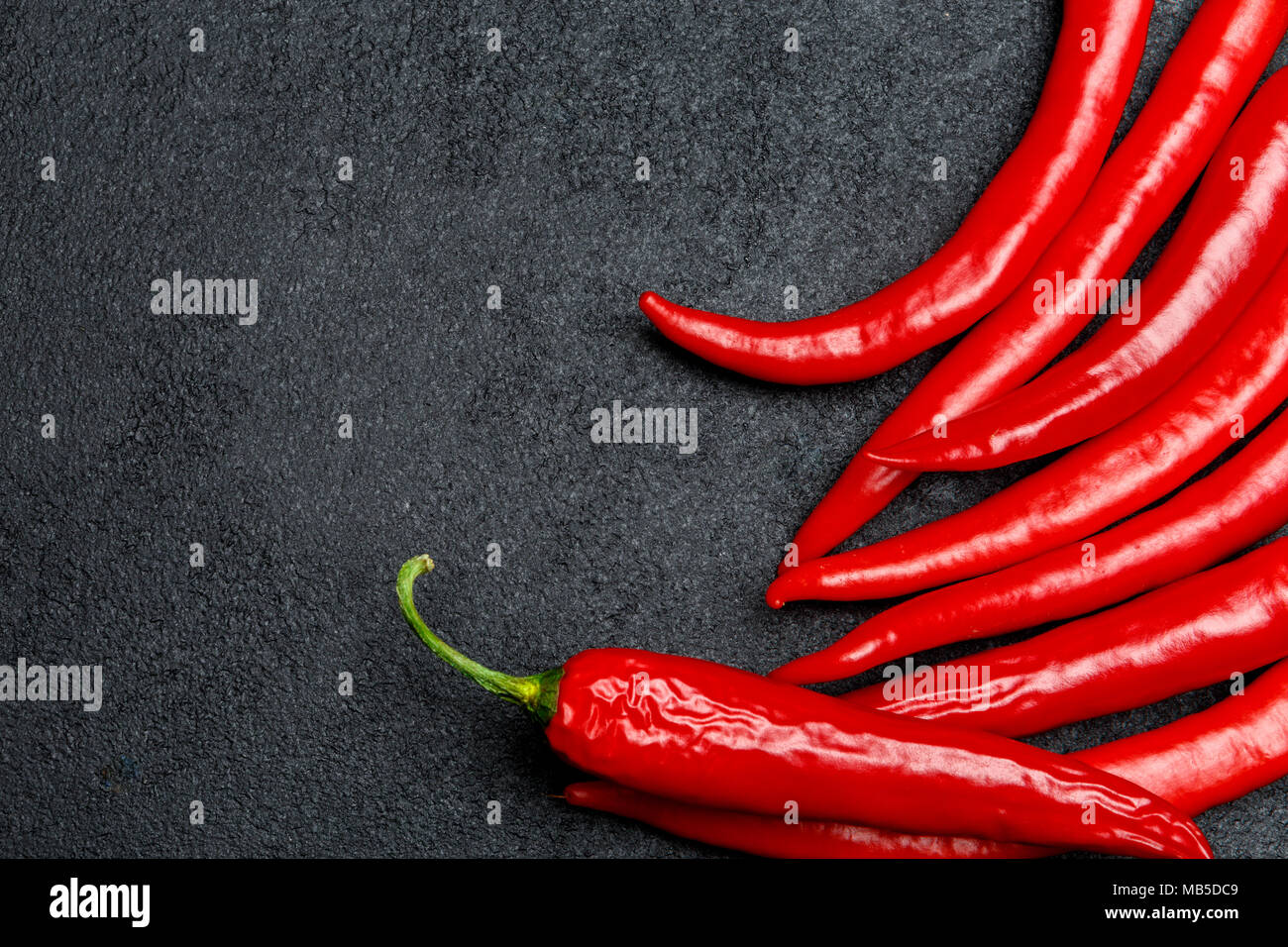 red chili pepper on dark concrete background Stock Photo - Alamy