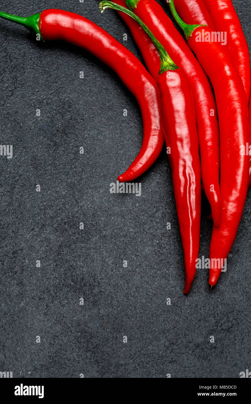 red chili pepper on dark concrete background Stock Photo - Alamy