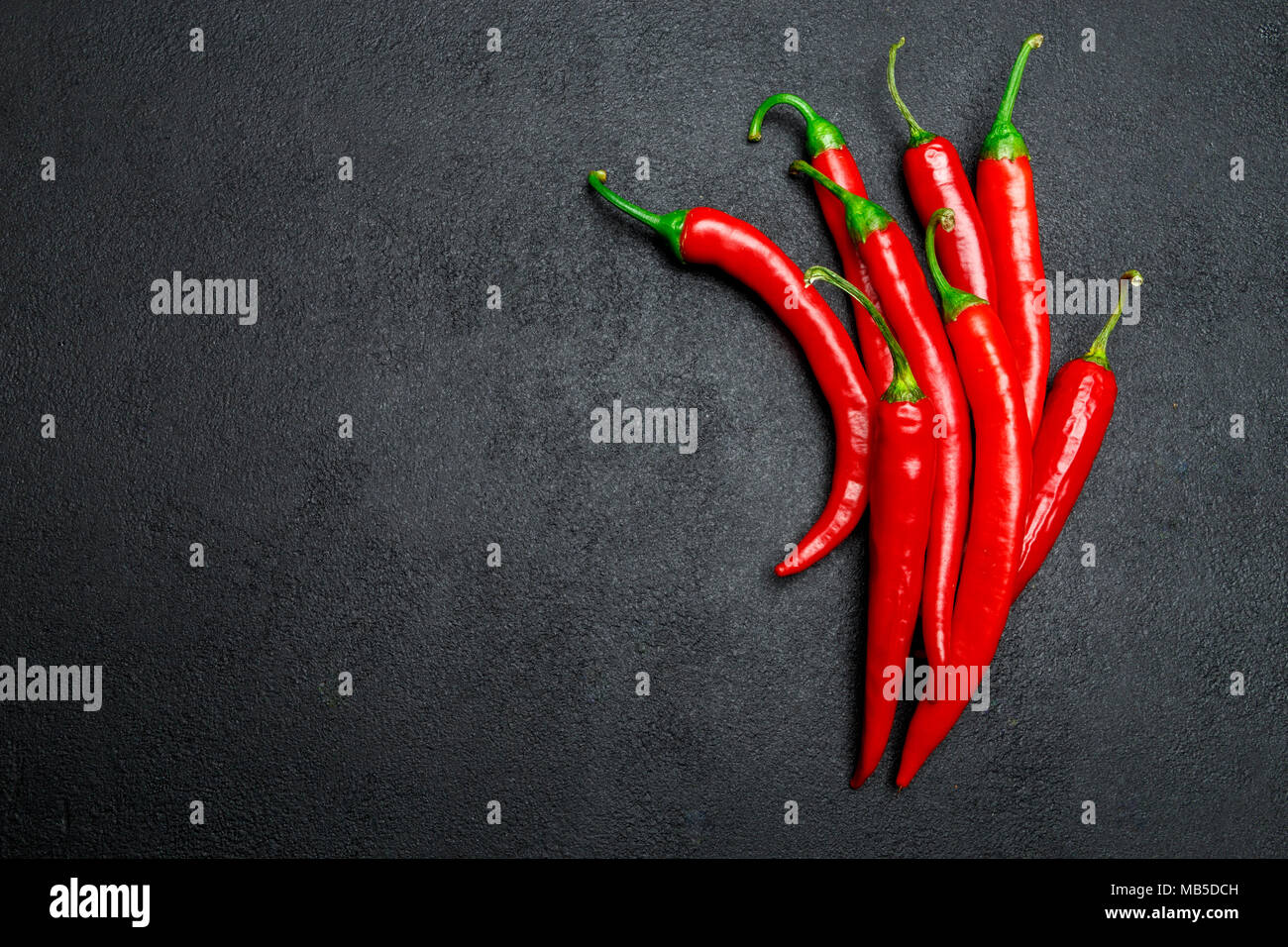 red chili pepper on dark concrete background Stock Photo - Alamy