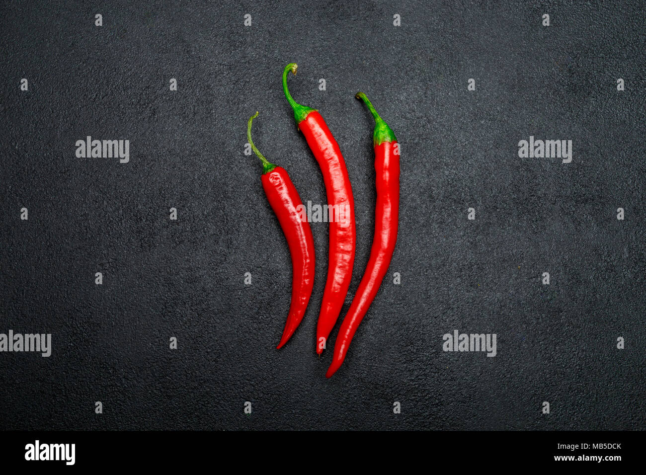 red chili pepper on dark concrete background Stock Photo - Alamy
