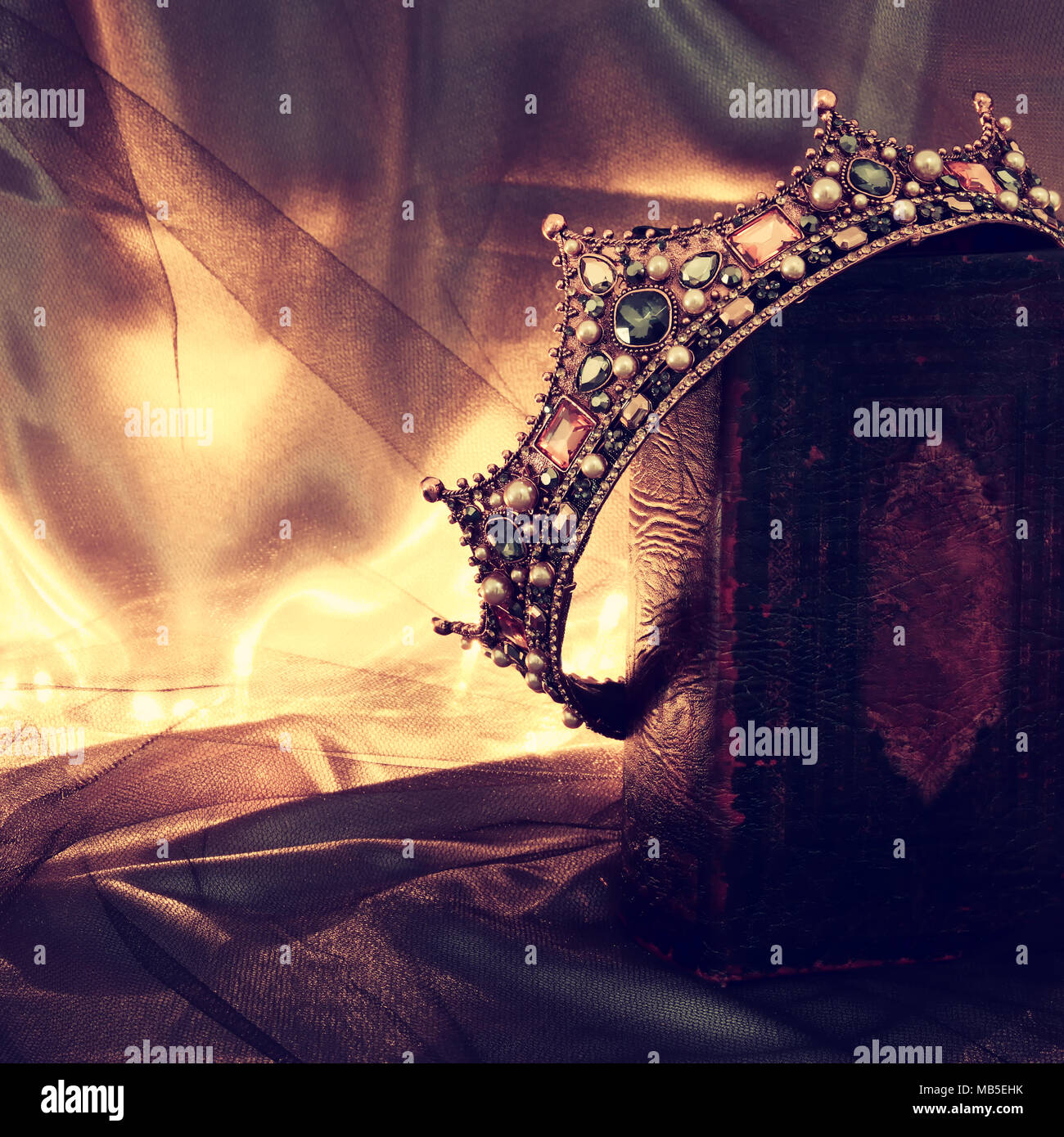 low key image of beautiful queen/king crown on old book. fantasy ...