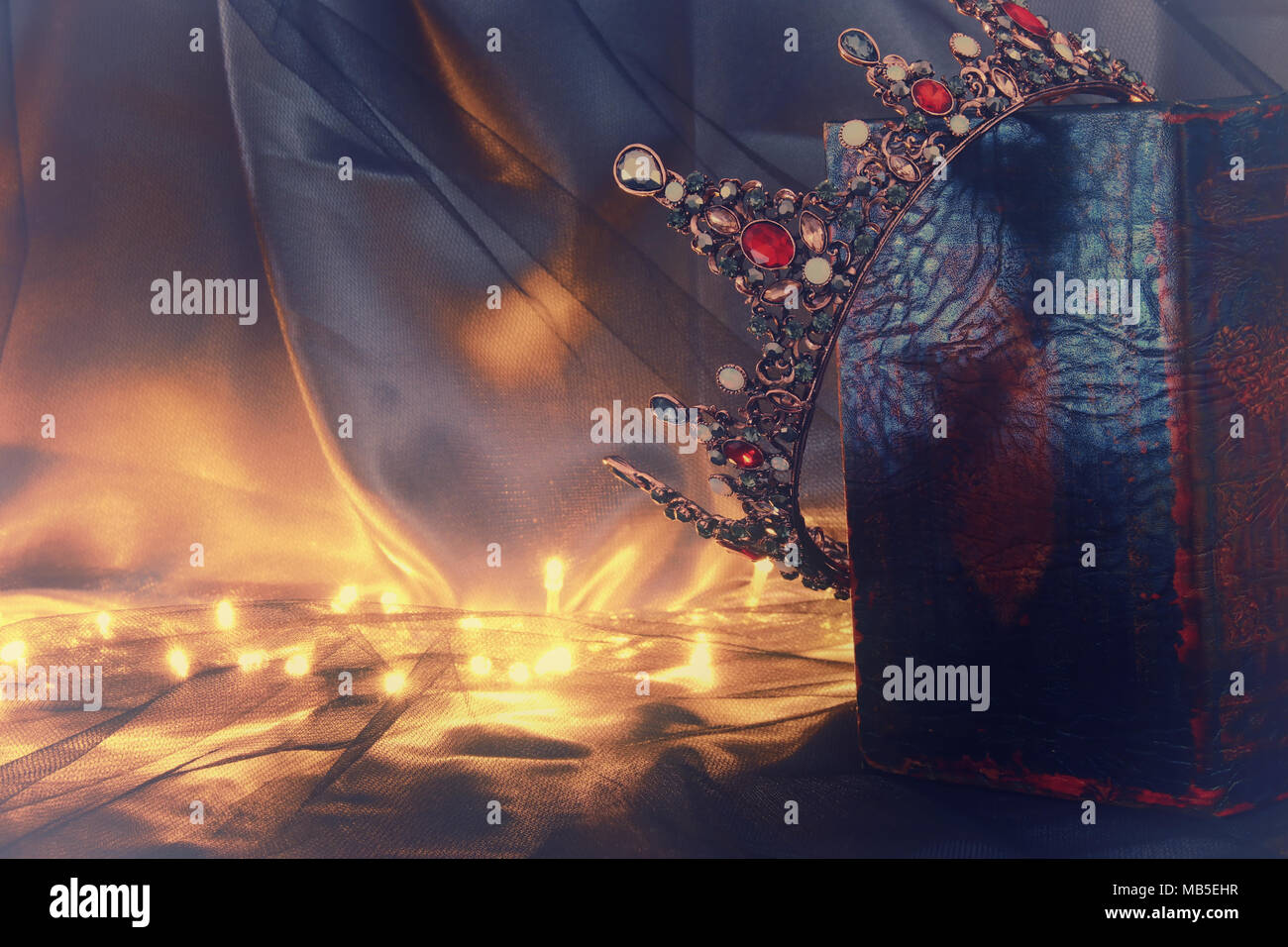 low key image of beautiful queen/king crown on old book. fantasy ...