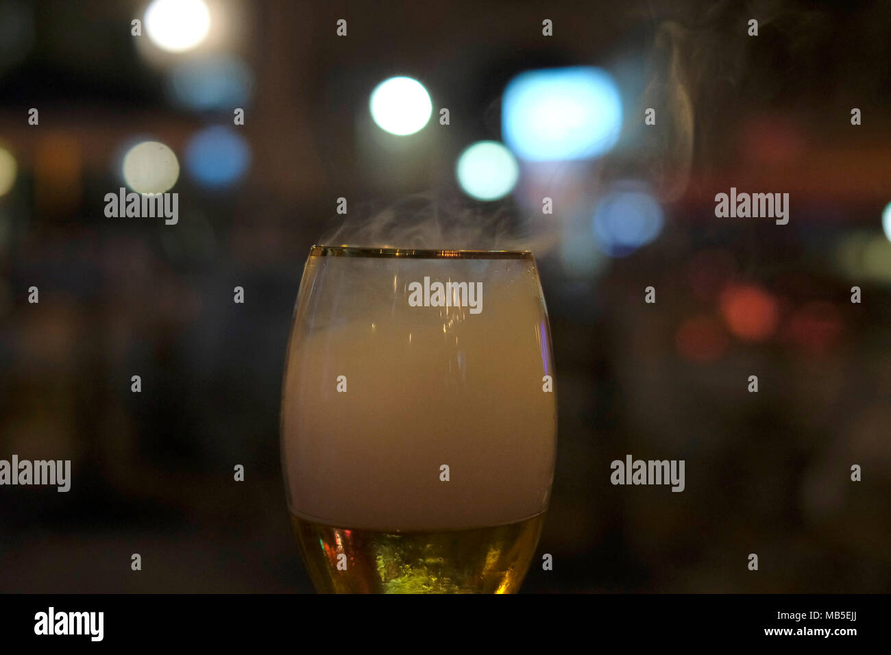 A glass of beer filled with smoke of cigarette Stock Photo - Alamy