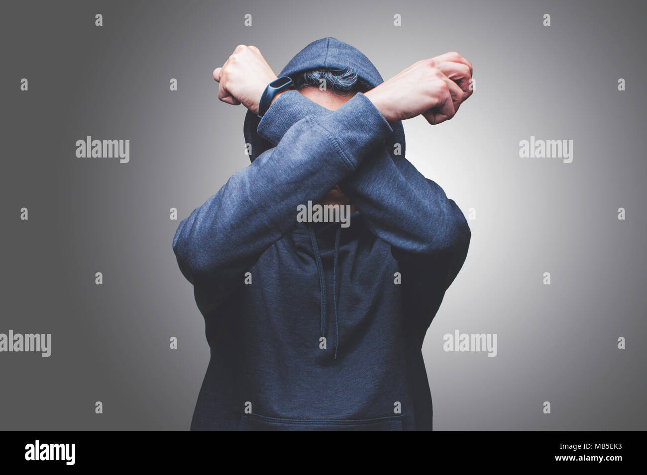 view of a man protecting himself with his arms hiding his face Stock ...