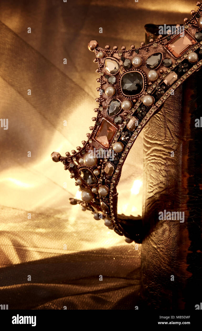 low key image of beautiful queen/king crown on old book. fantasy ...