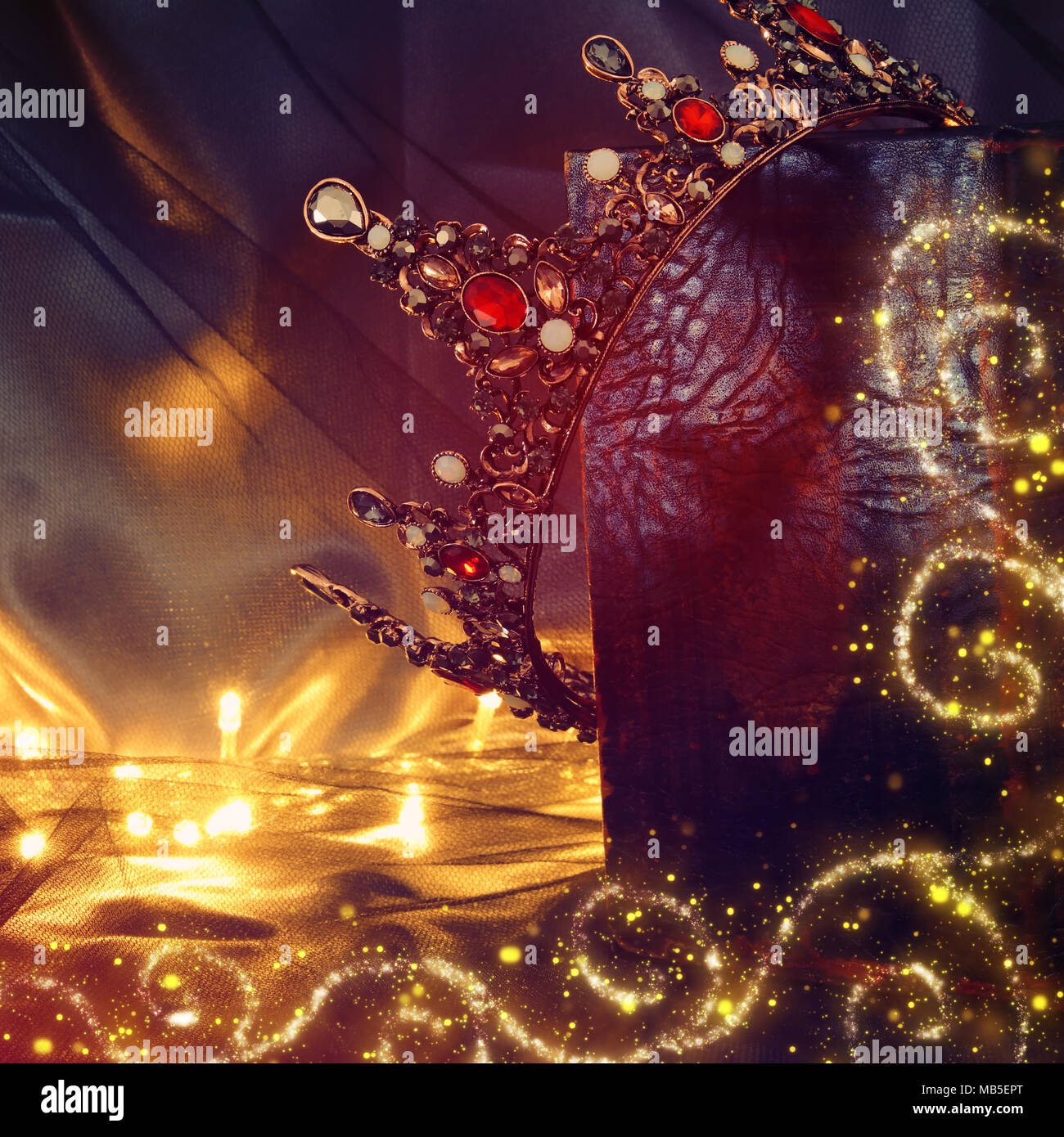 low key image of beautiful queen/king crown on old book. fantasy ...