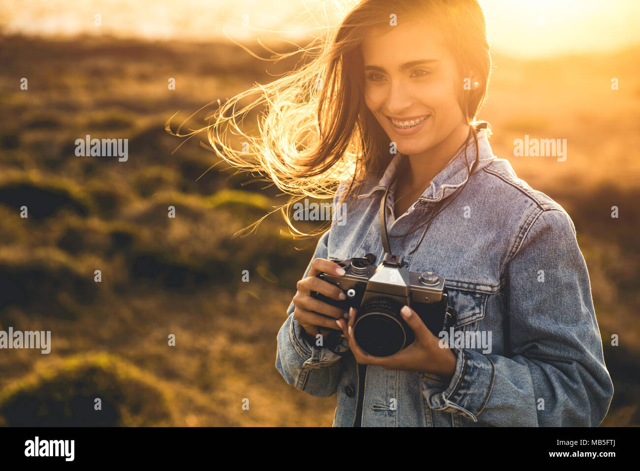 Beautiful woman taking picture outdoors with a analog camera Stock ...