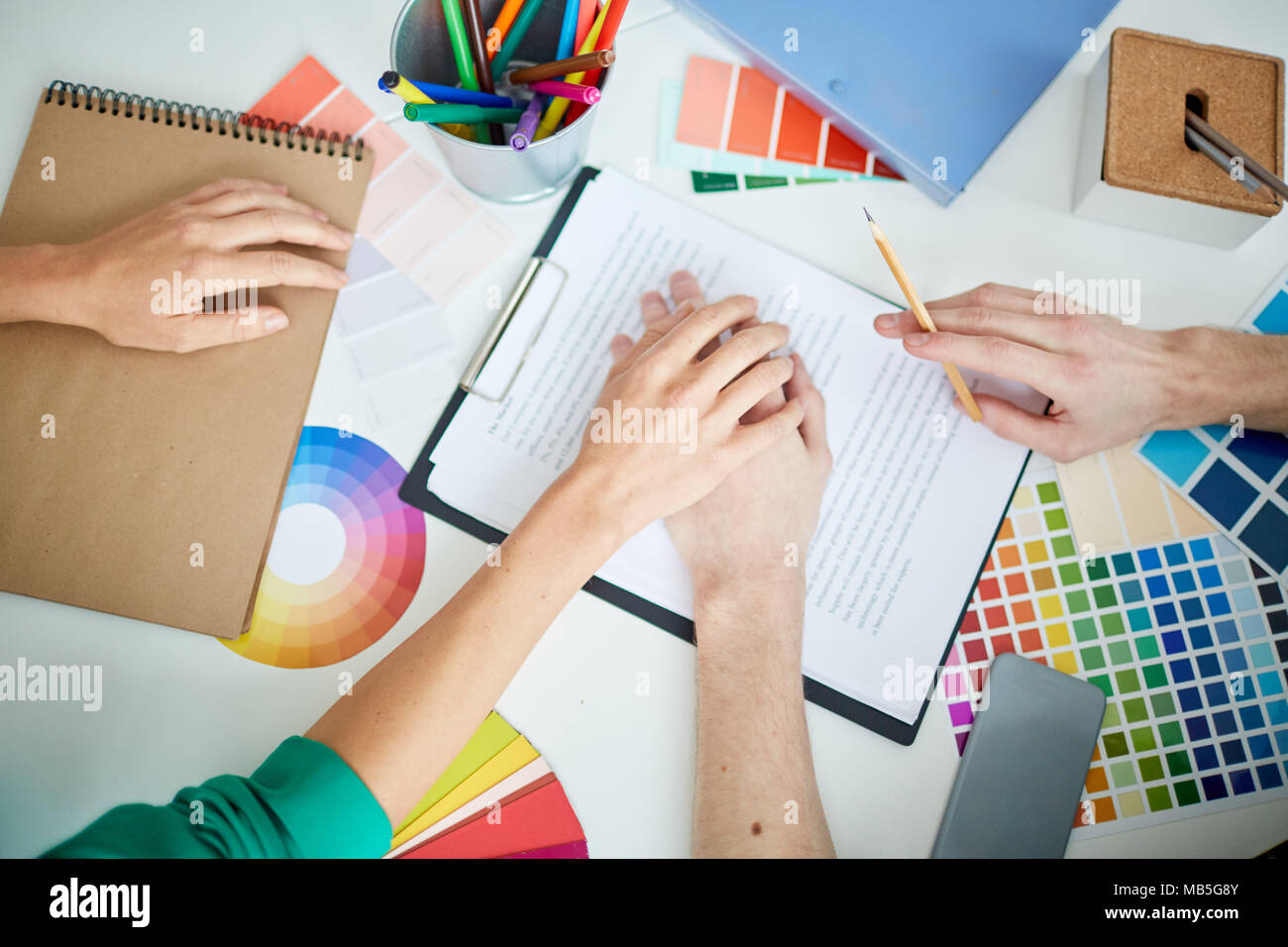 Close-up view of interior designers teamwork with samples and contract ...