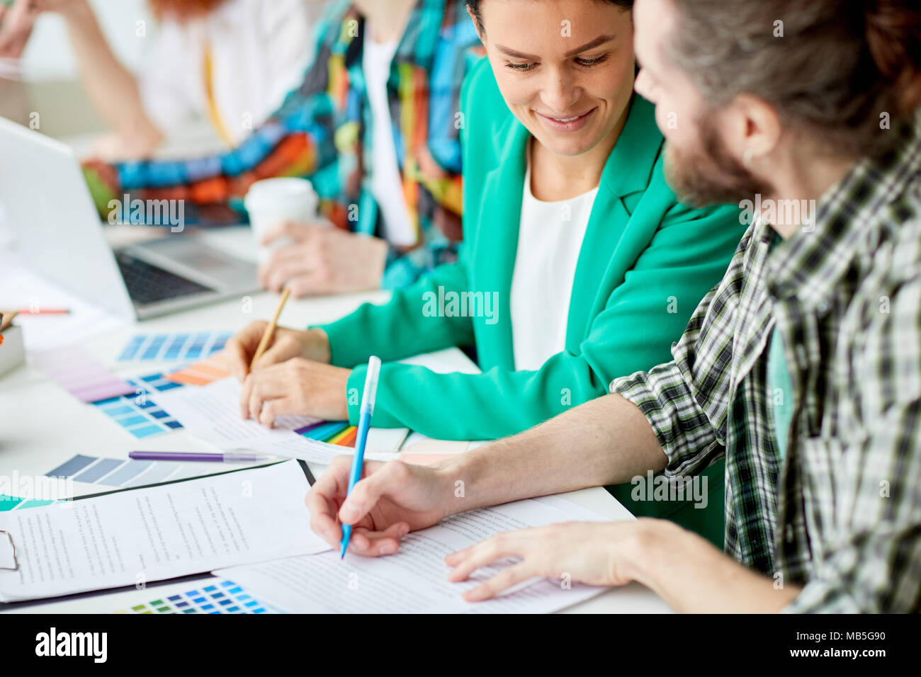 Interior designers sitting at the table and working with color palette ...