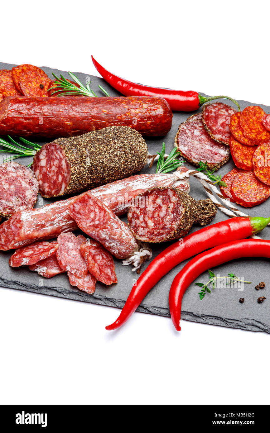Various types of Dried organic salami sausage on stone serving board ...