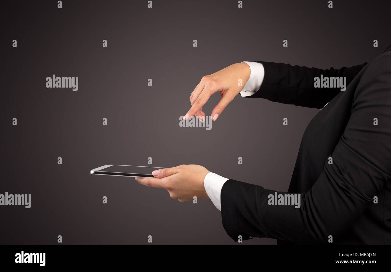 Female hand in suit holding tablet with no wallpaper Stock Photo - Alamy