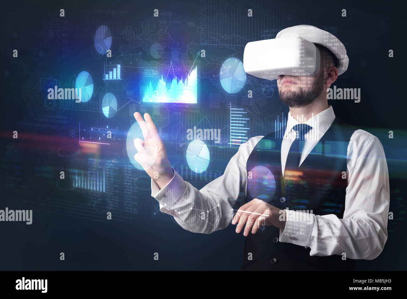 Elegant businessman in DJI goggles handling 3D reports and charts ...
