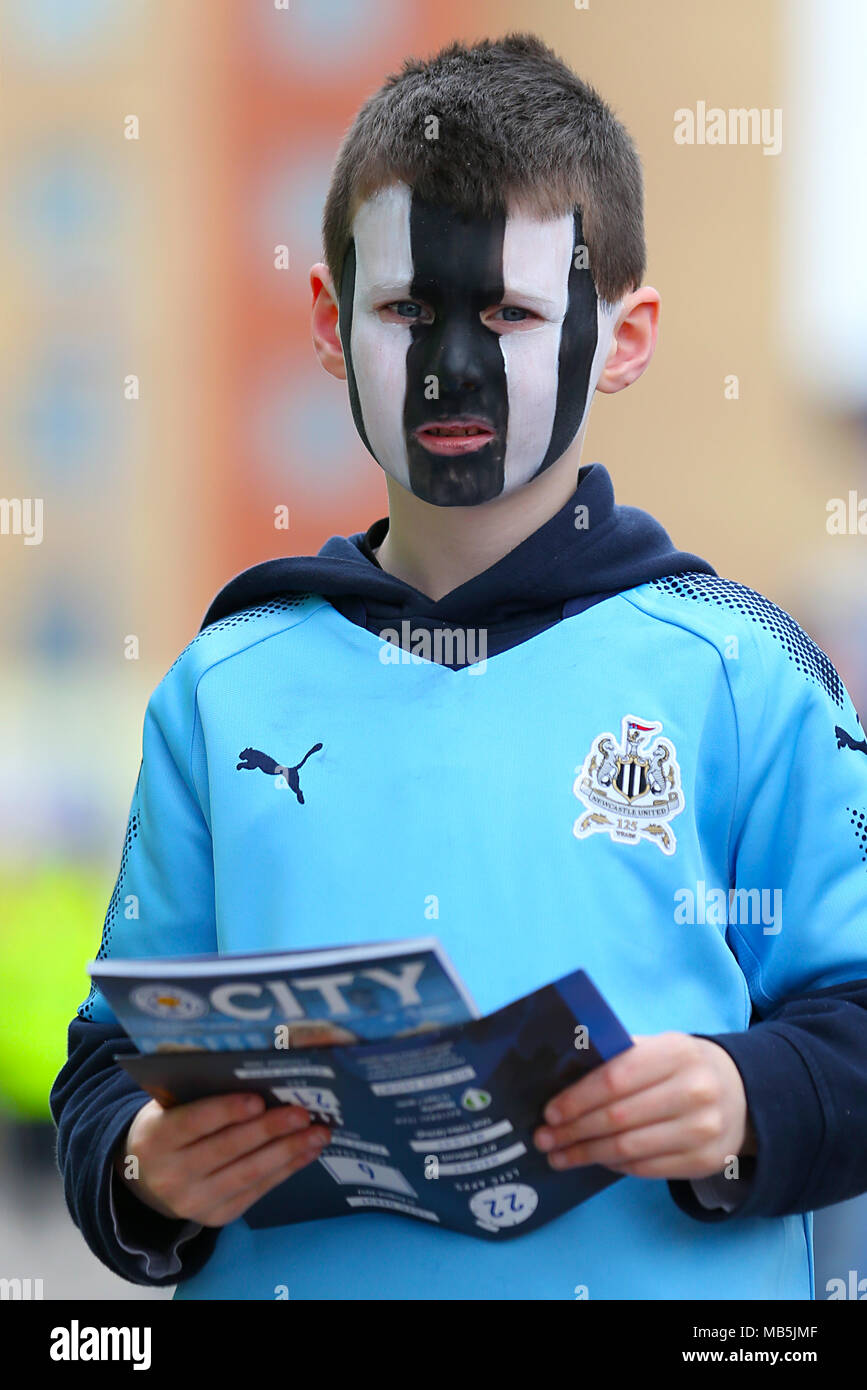 A young Newcastle United fan wears facepaint ahead of the Premier ...
