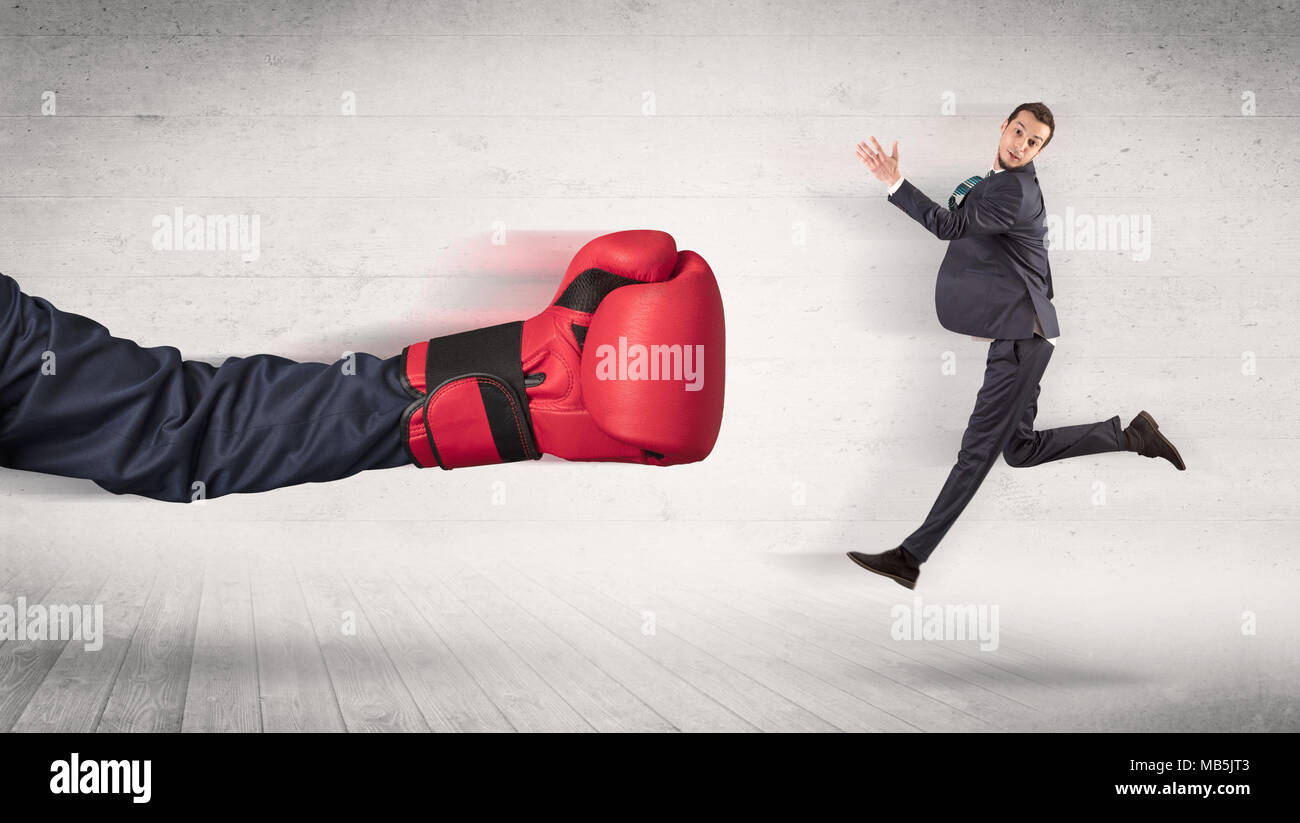 Arm with red boxing gloves hits office worker concept Stock Photo - Alamy