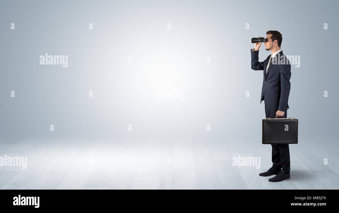 Businessman looking forward with binoculars in an empty space Stock ...