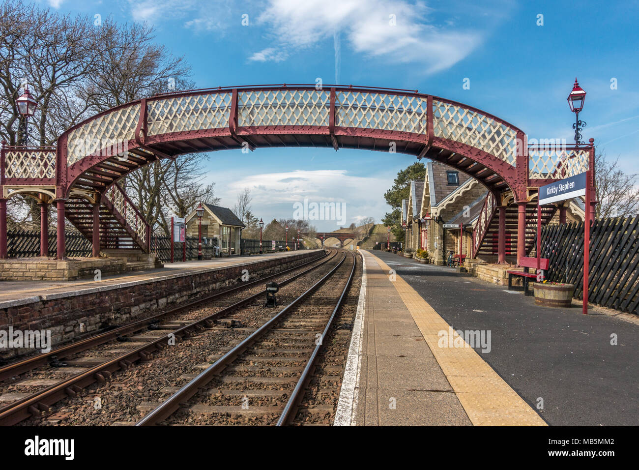 Looking down the salt gritted platform and railway tracks of Kirkby ...