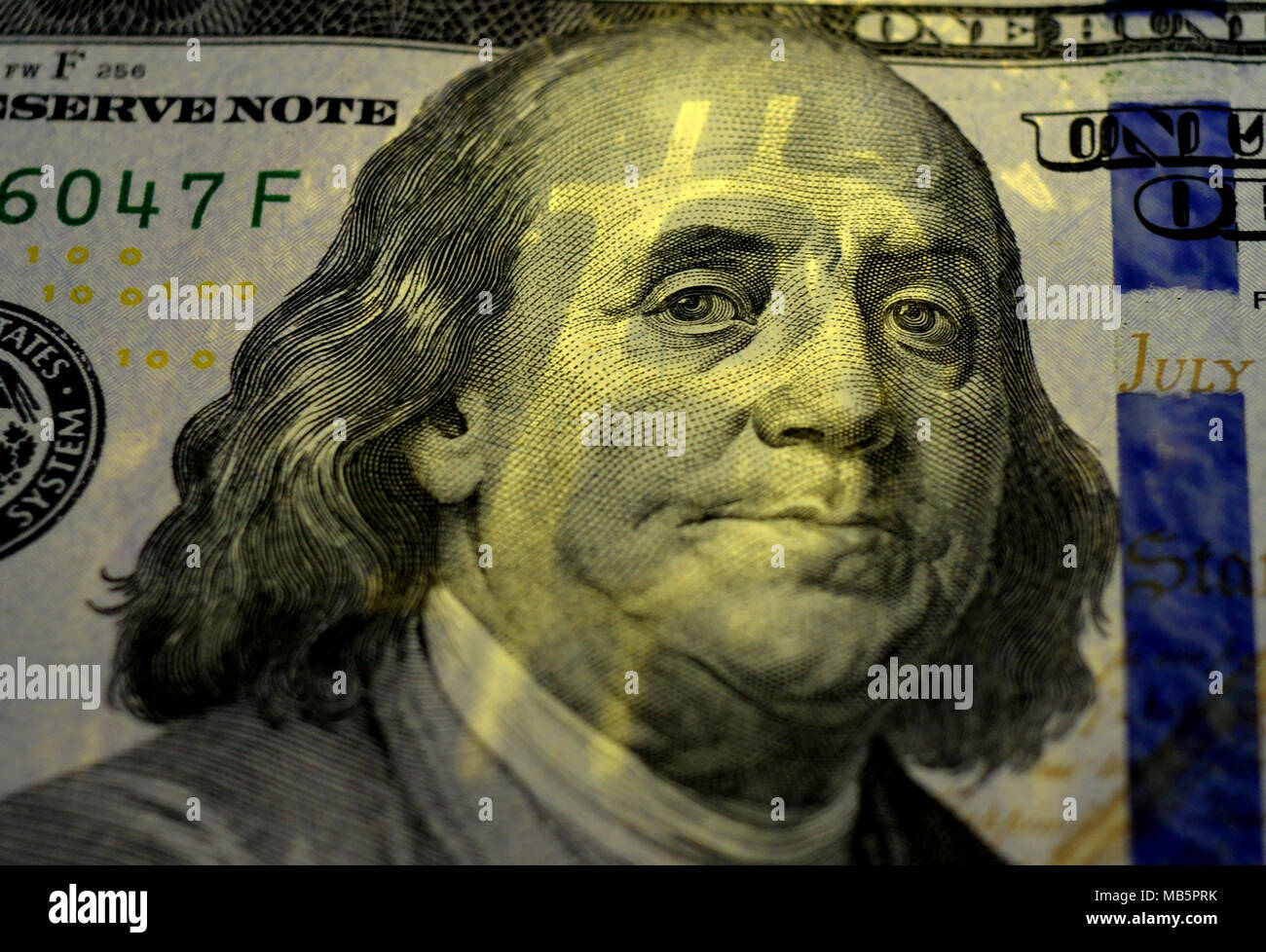 The shadow of Bitcoin on Benjamin Franklin's face on the one hundred ...