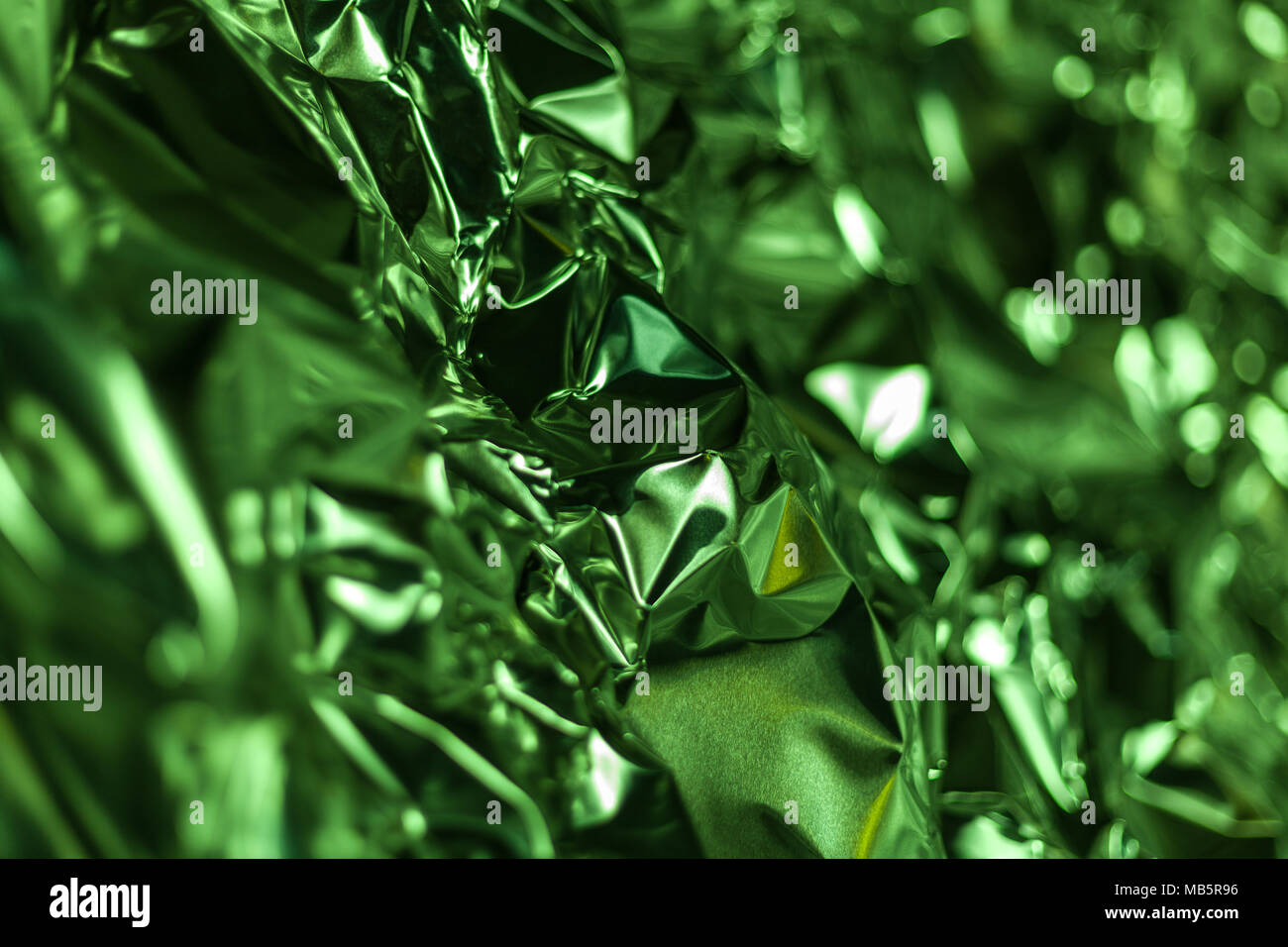 Full frame take of a sheeT of crumpled green aluminum foil background ...