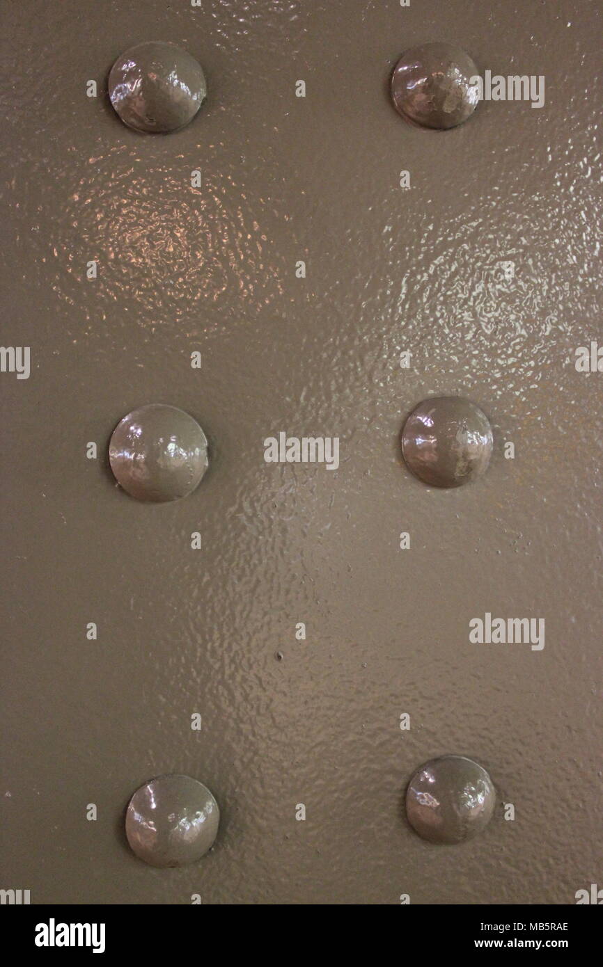 Gray riveted steel column painted with beige paint Stock Photo - Alamy