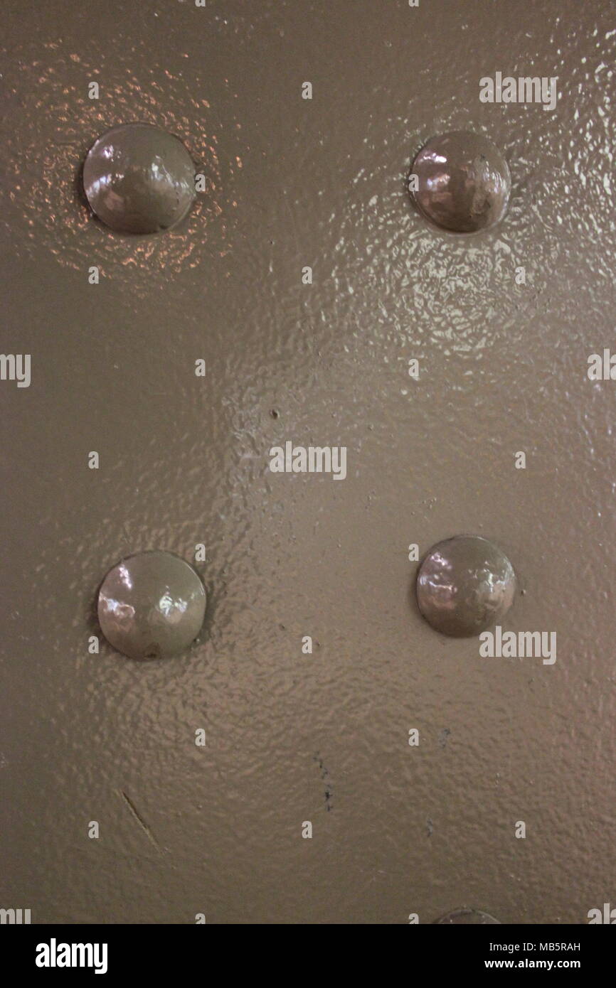 Gray riveted steel column painted with beige paint Stock Photo - Alamy