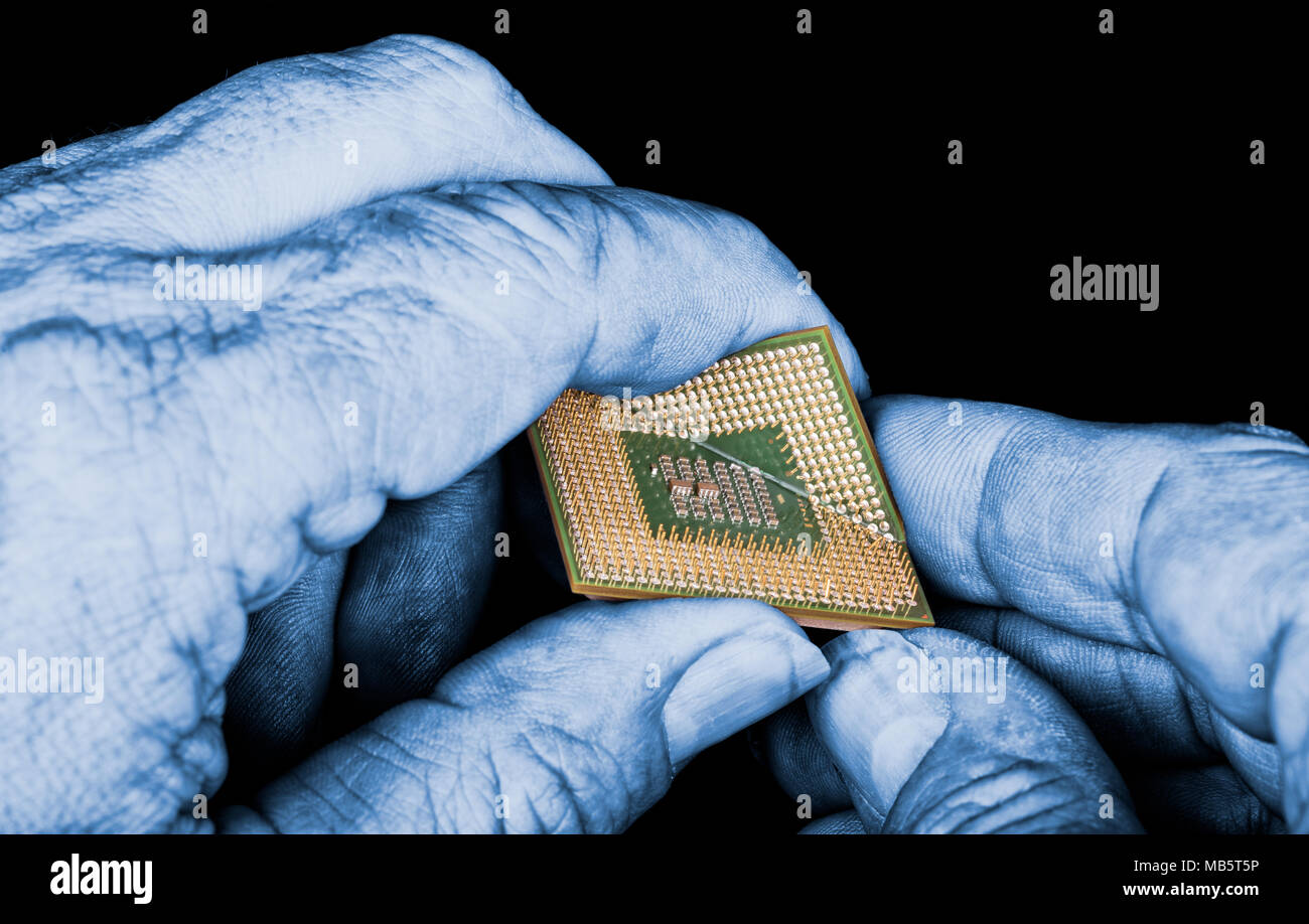 Mysterious hands destroy processor with critical error. Close-up of broken computer chip in spy ...